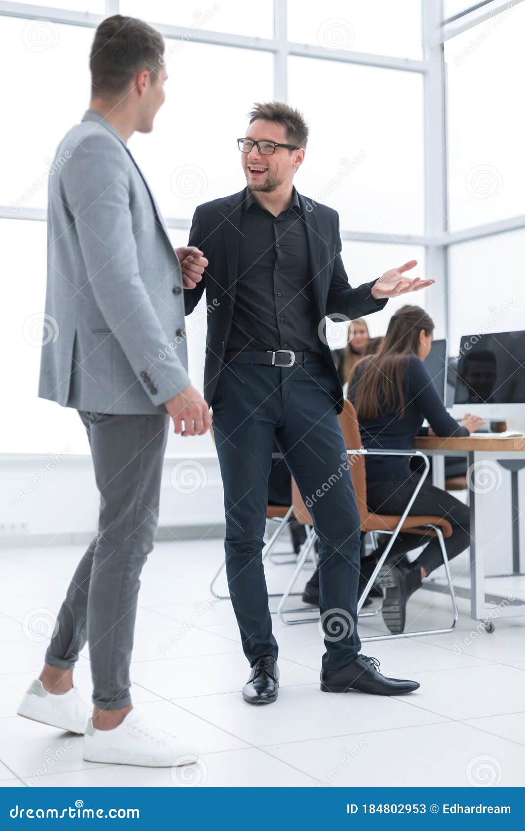 In Full Growth. Smiling Employees Discussing Something in the Office ...