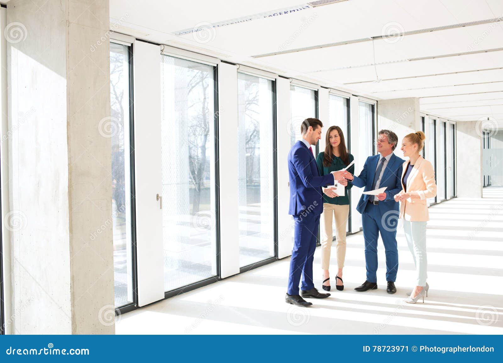 Full Length of Business People Discussion Over Documents in Empty ...