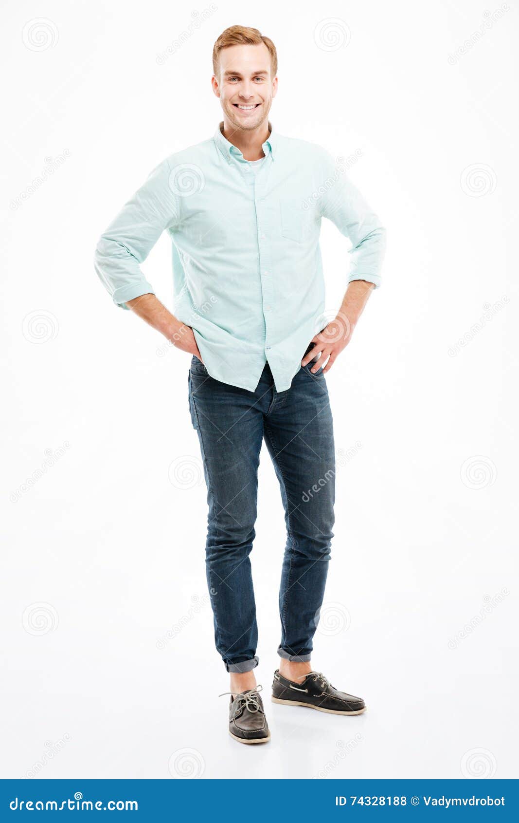 Full Length Of Cheerful Handsome Young Man Standing And Smiling Stock
