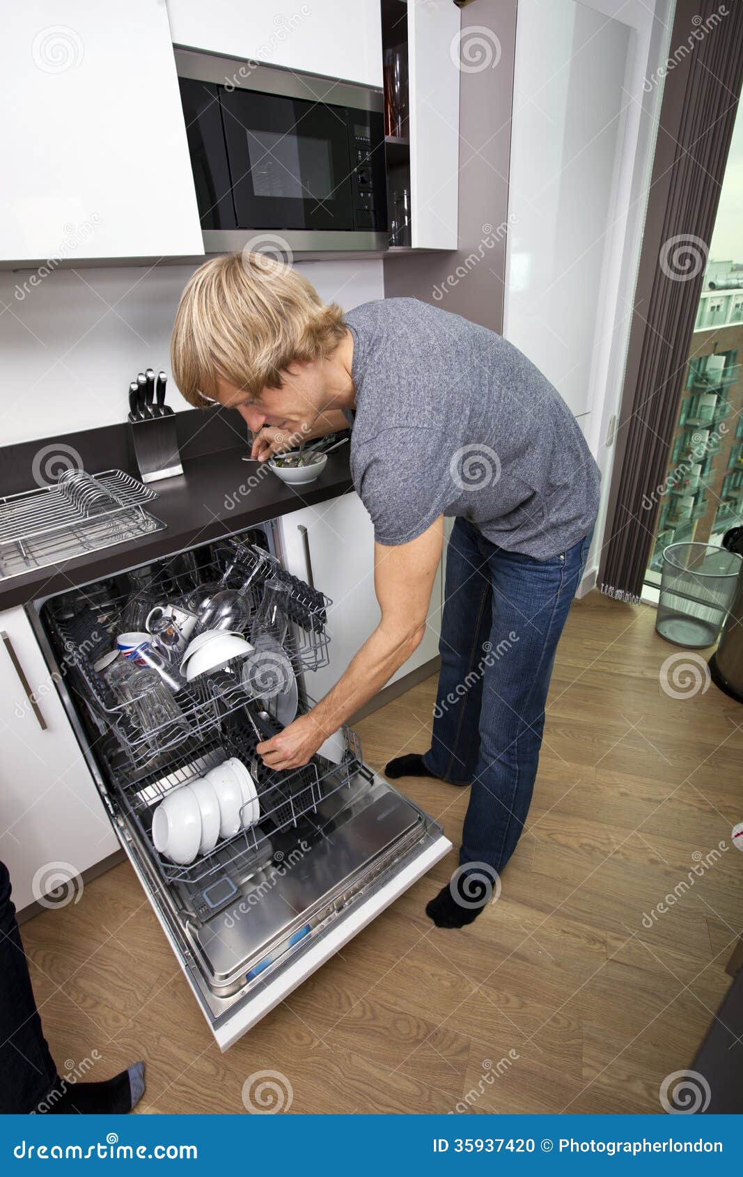 Full Length of Man Loading Dishwasher in Kitchen Stock Photo - Image of ...