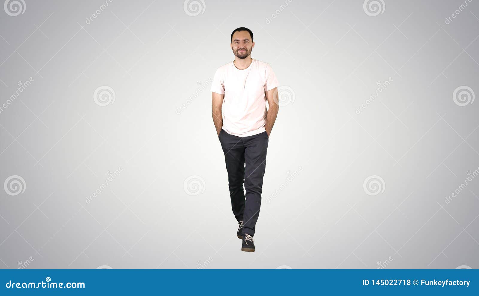Confident Young Adult Man Walking Forwards and Looking at Camera in ... Confident Young Adult Man Walking Forwards and Looking at Camera in ...
