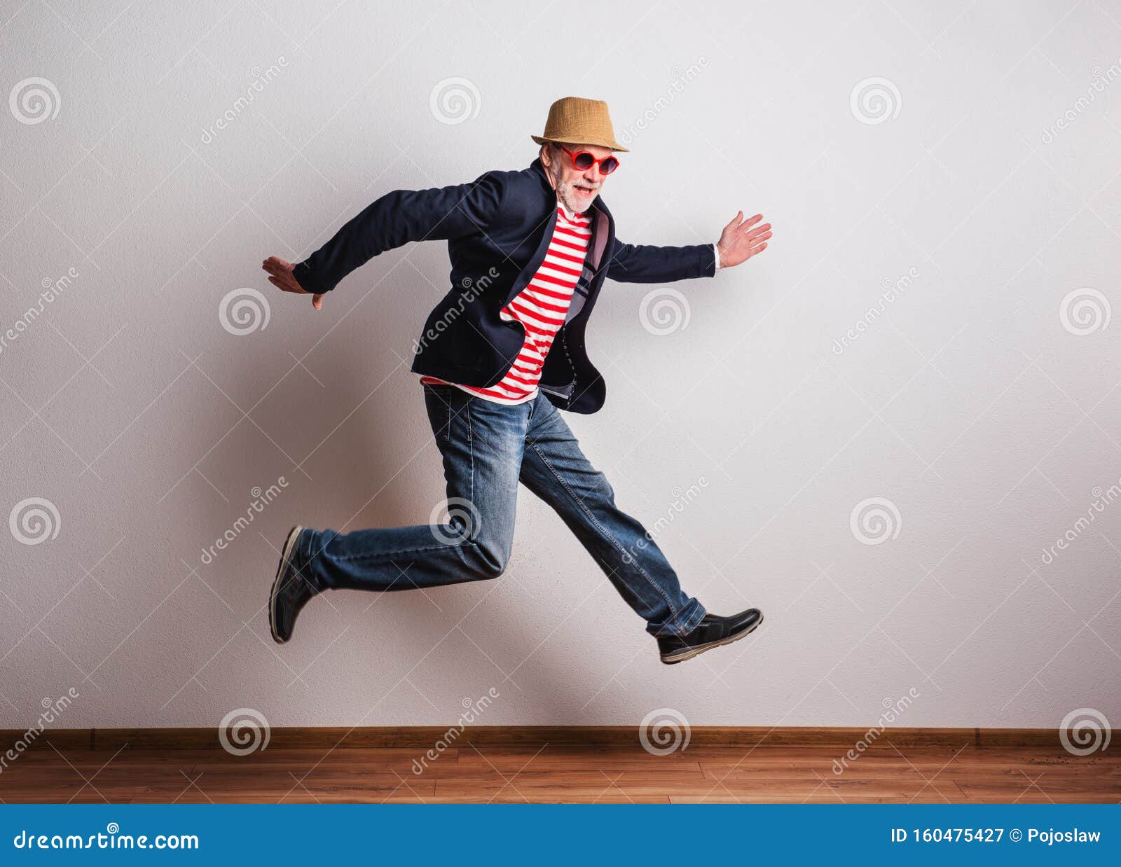 Full Length Portrait of a Senior Man in a Studio, Jumping. Stock Image ...