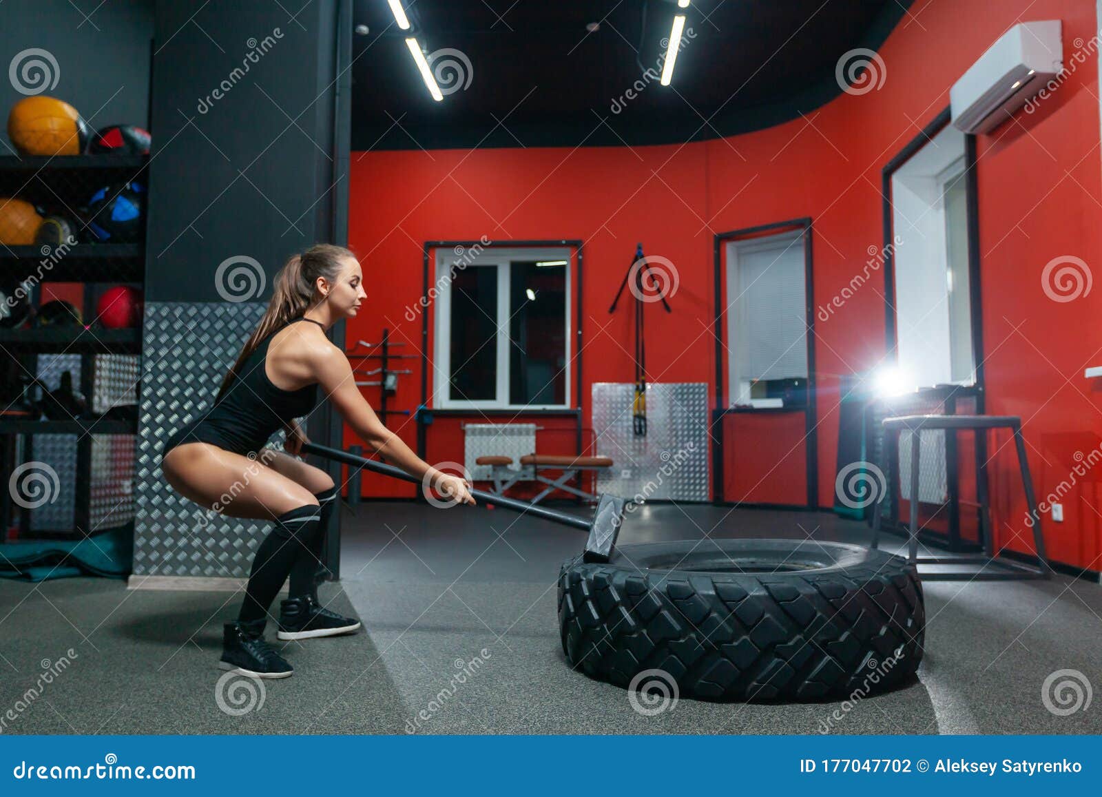Full Length Portrait Of Sporty Strong Muscular Girl Training With
