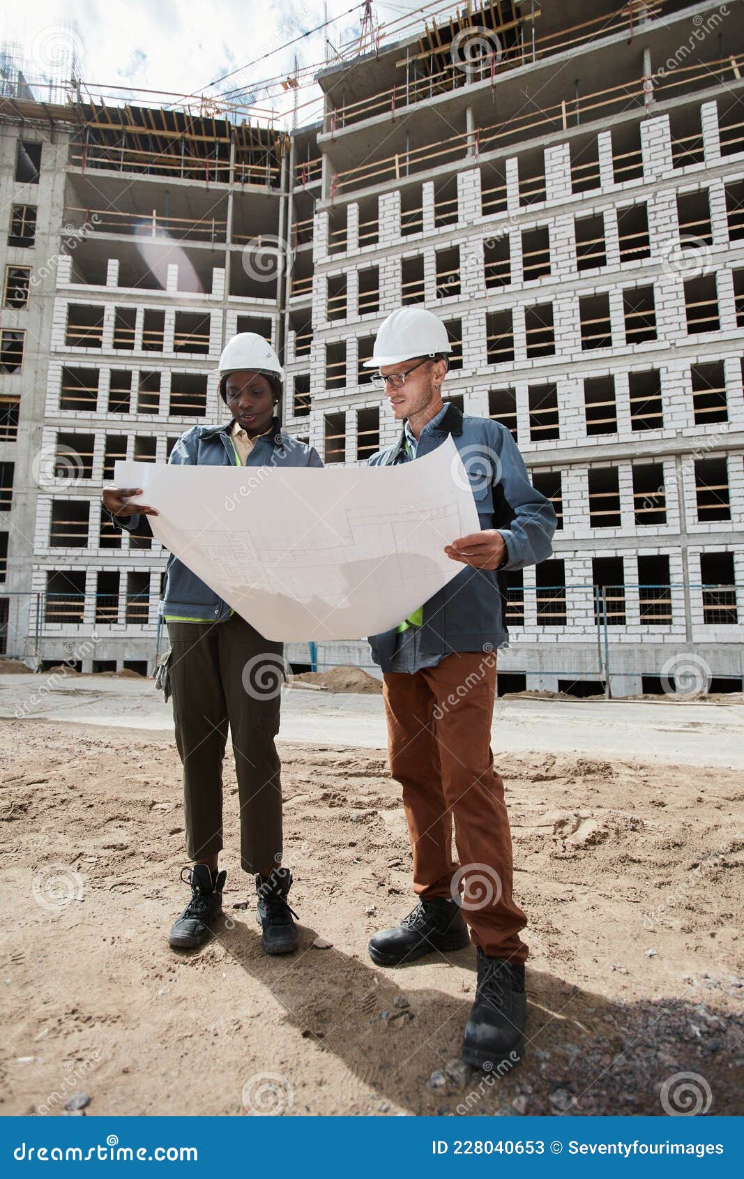 Two Construction Workers Holding Blueprint Stock Image - Image of ...