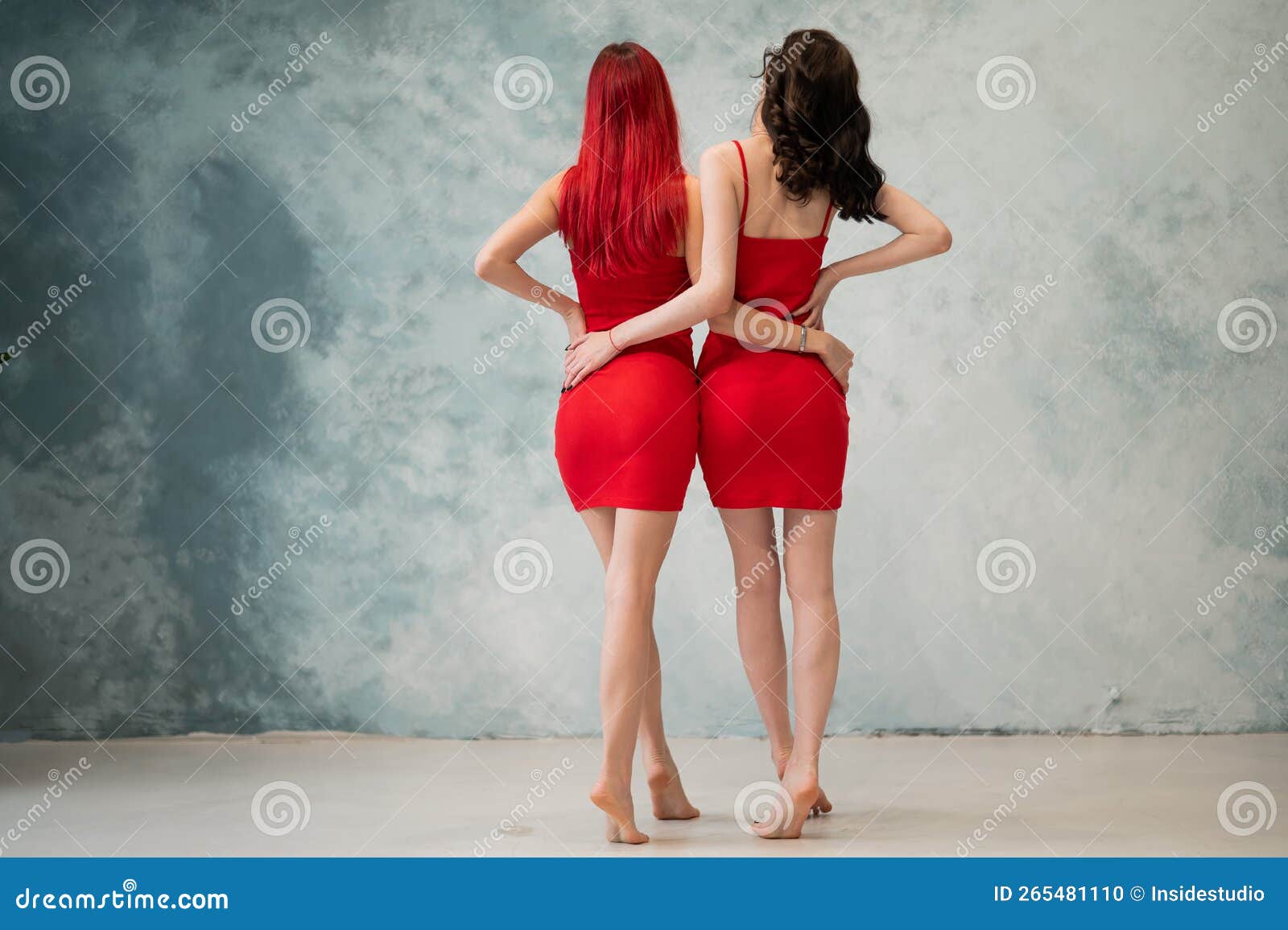 Full Length Portrait Of Two Tenderly Embracing Women Dressed In