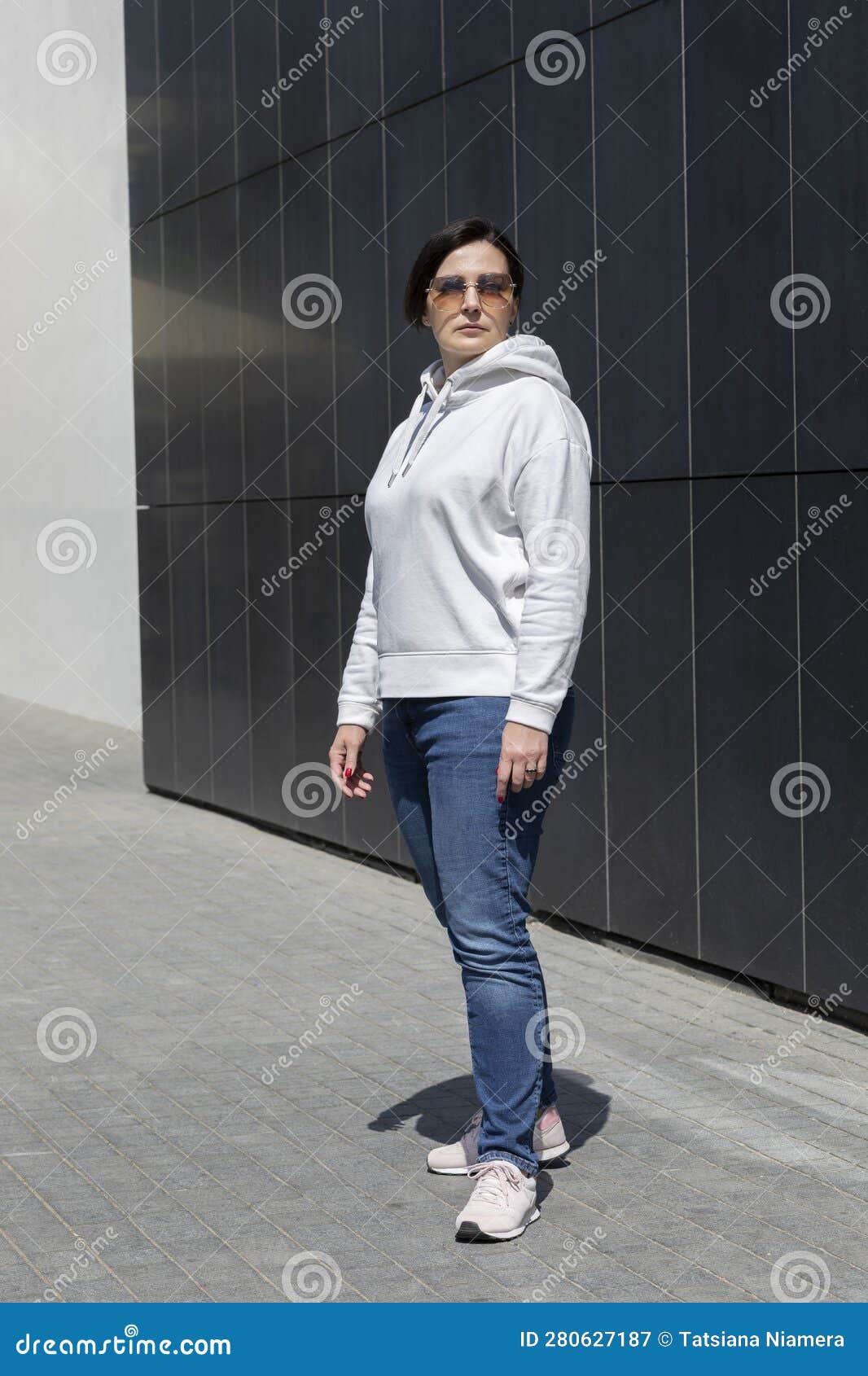 Full Length Pretty Mature Brunette Woman In White Hoodie Jeans And