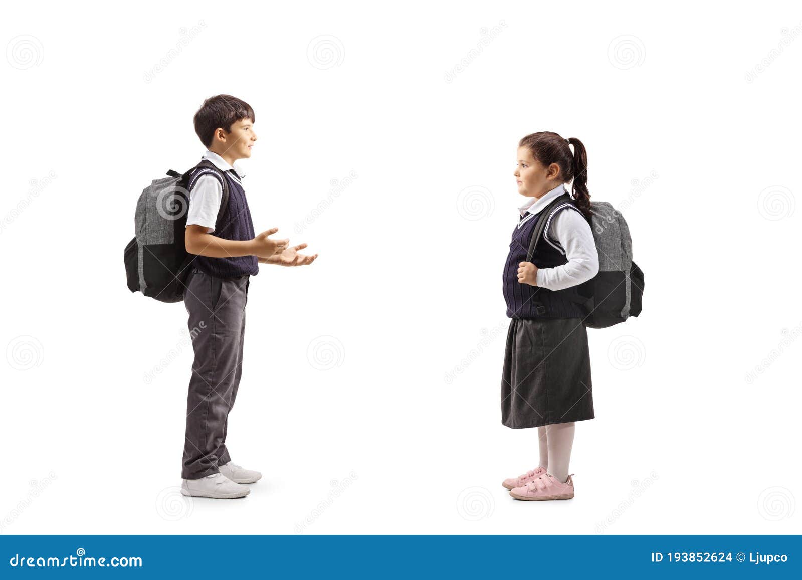 Full Length Profile Shot of Pupils in Uniforms Having a Conversation ...