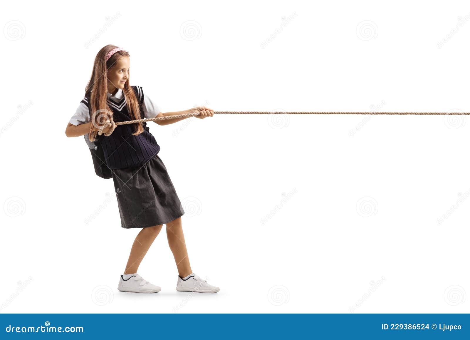 Full Length Profile Shot of a Schoolgirl Pulling a Rope Stock Photo ...