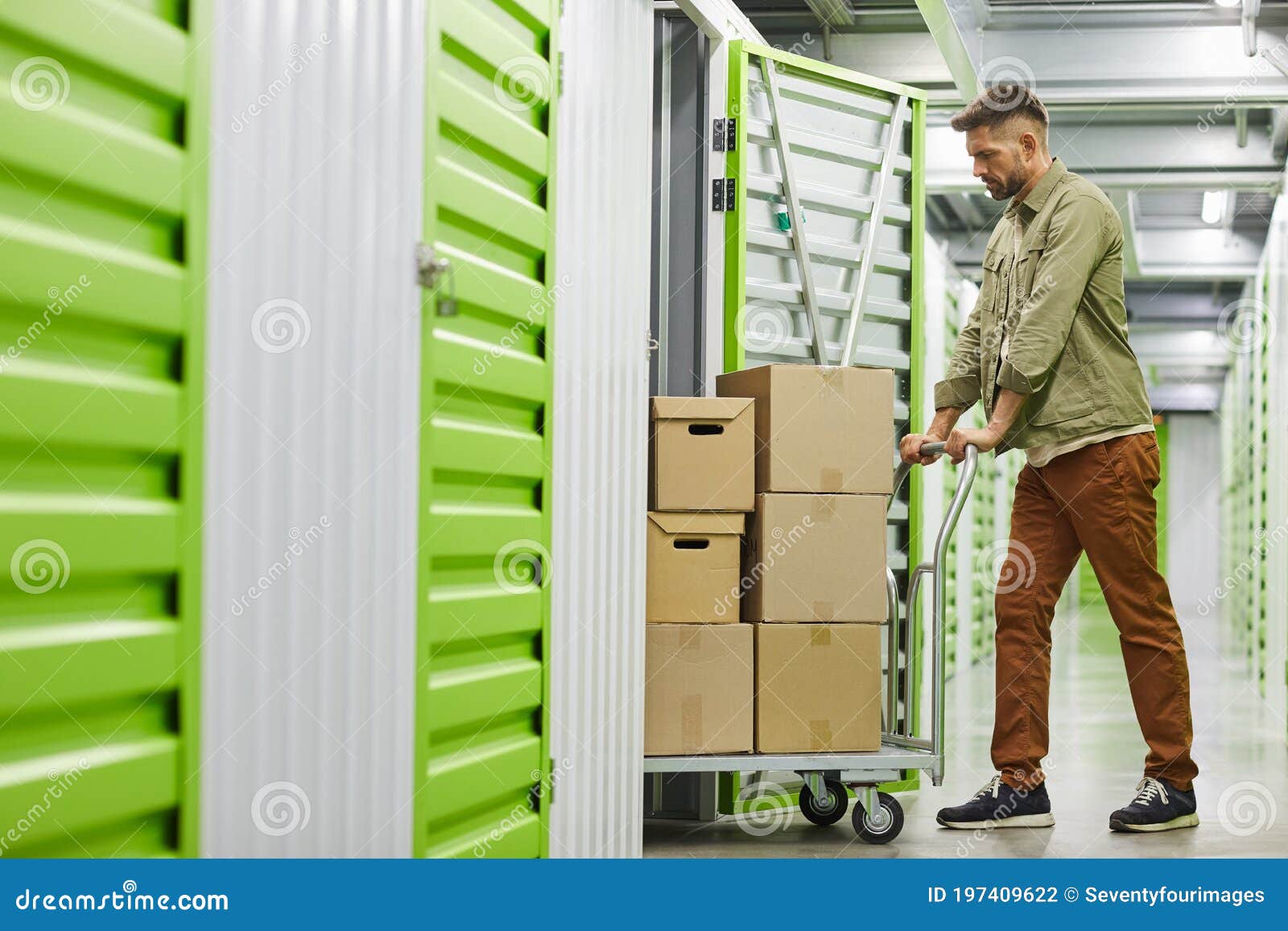 Man Moving Boxes in Storage Unit Stock Photo - Image of working ...