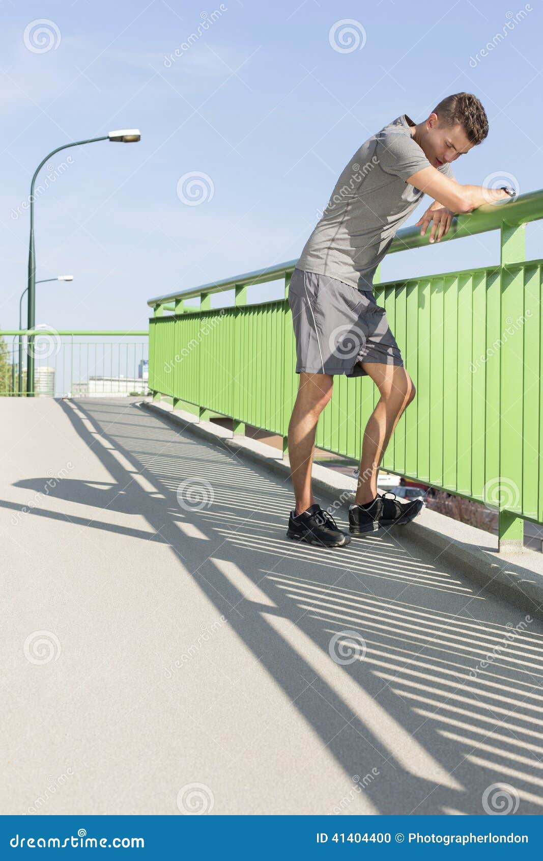 Full Length of Tired Young Man Leaning on Railing after Jogging Stock ... Full Length of Tired Young Man Leaning on Railing after Jogging Stock ...