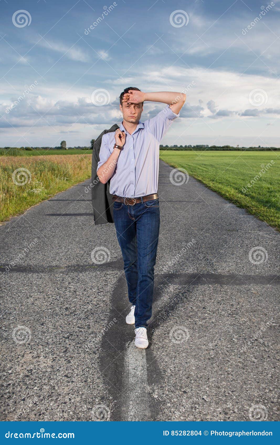 Full Length of Tired Young Man Walking Alone on Rural Road Stock Photo ...