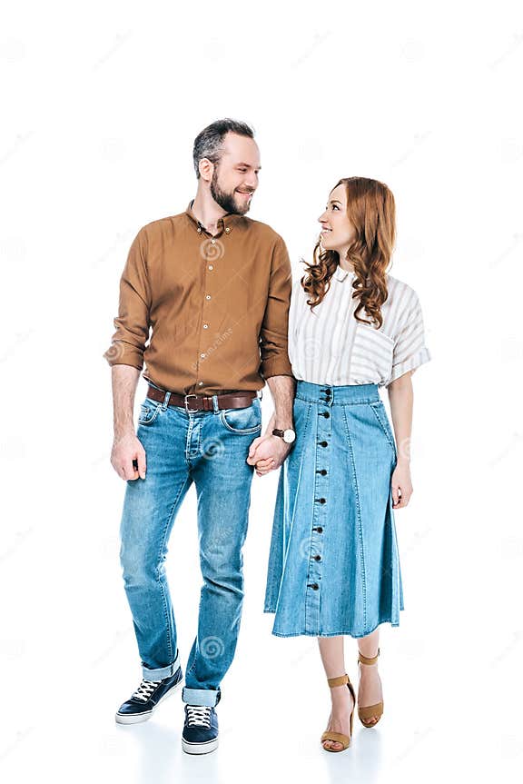 Full Length View Of Happy Couple Holding Hands And Smiling Each Other