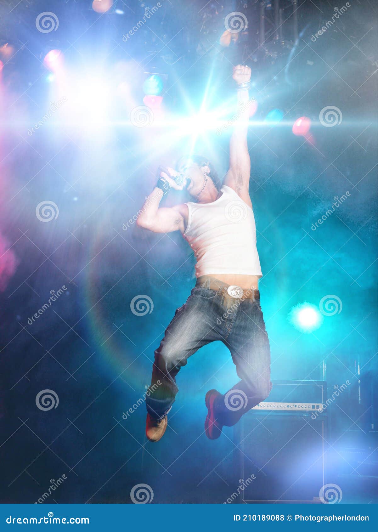 Full Length of a Young Man Singing and Jumping on Stage at Concert ...
