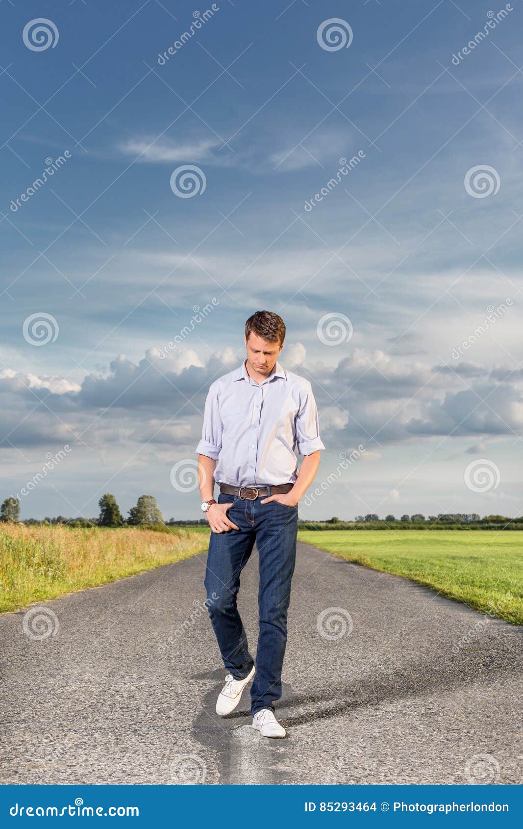 Full Length of Young Man Walking on Empty Rural Road Stock Photo ...