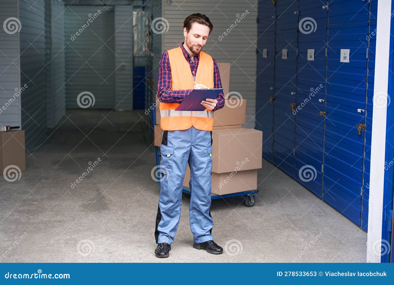 Full Length of Young Man in Work Clothes into Warehouse with Self ...