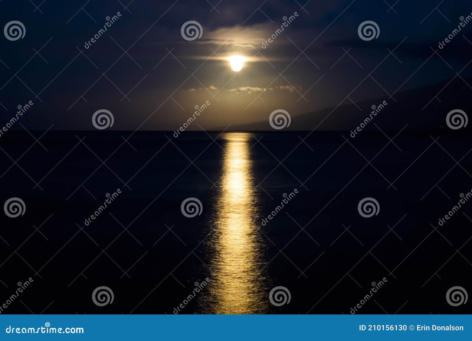 Full Moon Drips from Clouds with Light Reflecting on Ocean Surface ...