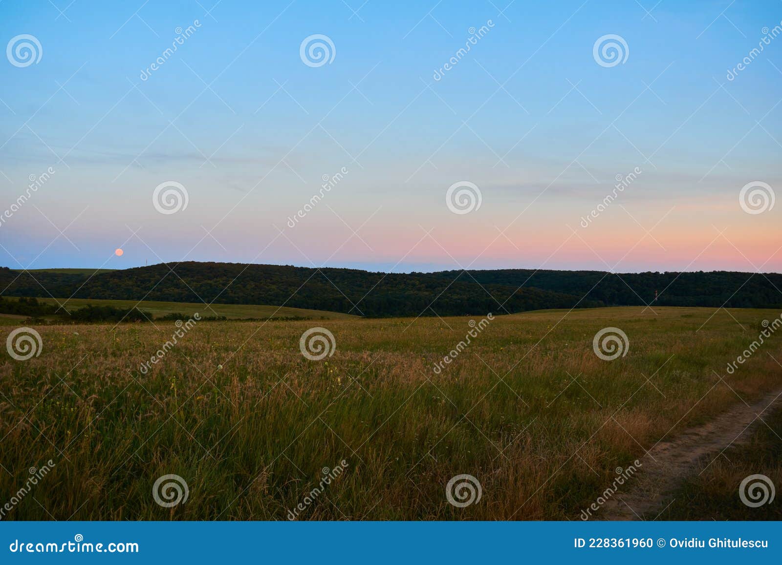 The Full Moon Over the Field and Hills at Sunset Stock Photo - Image of ...