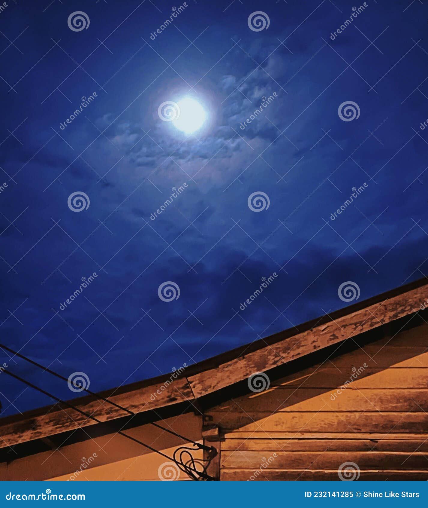 Full moon over rooftop stock image. Image of clouds - 232141285