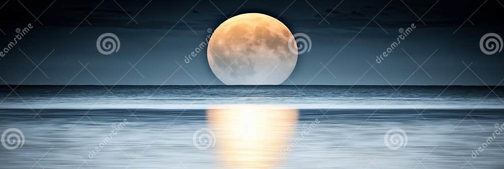Full Moon Rising Over the Ocean, Mirrored by Its Reflection on the ...