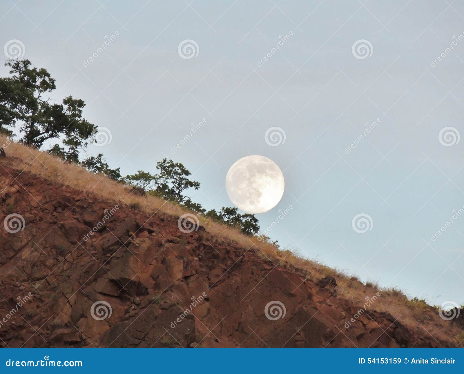 Full Moon Rising Over a Rocky Cliff Stock Image - Image of evening ...