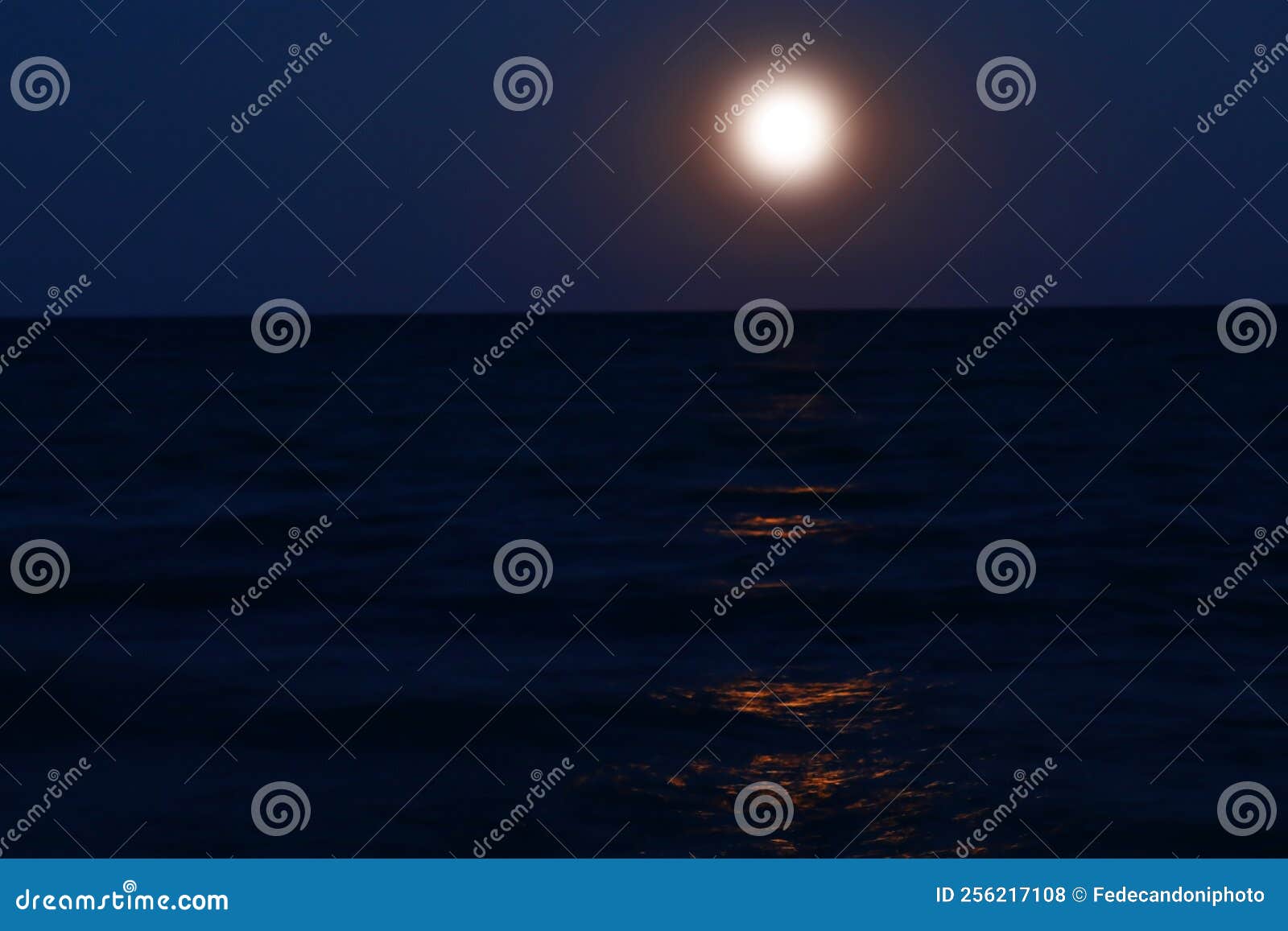 Full Moon Rising from the Sea with Reddish Effect that is Reflec Stock ...