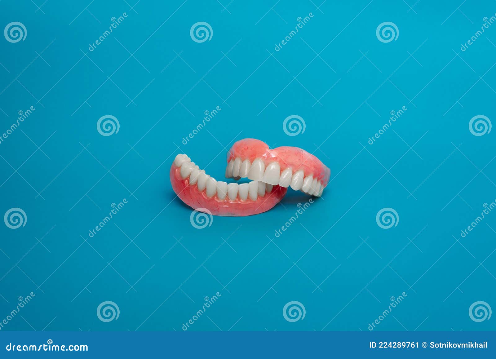 Full Removable Plastic Denture of the Jaws. Set of Dentures on a Blue ...