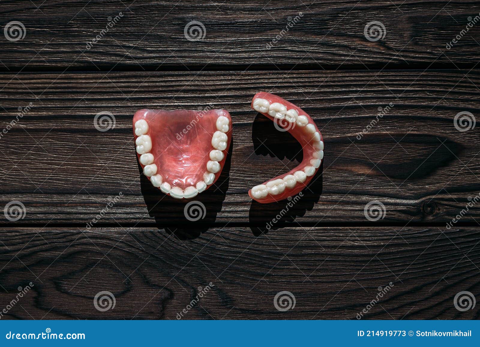 Full Removable Plastic Denture of the Jaws. a Set of Dentures on a Dark ...