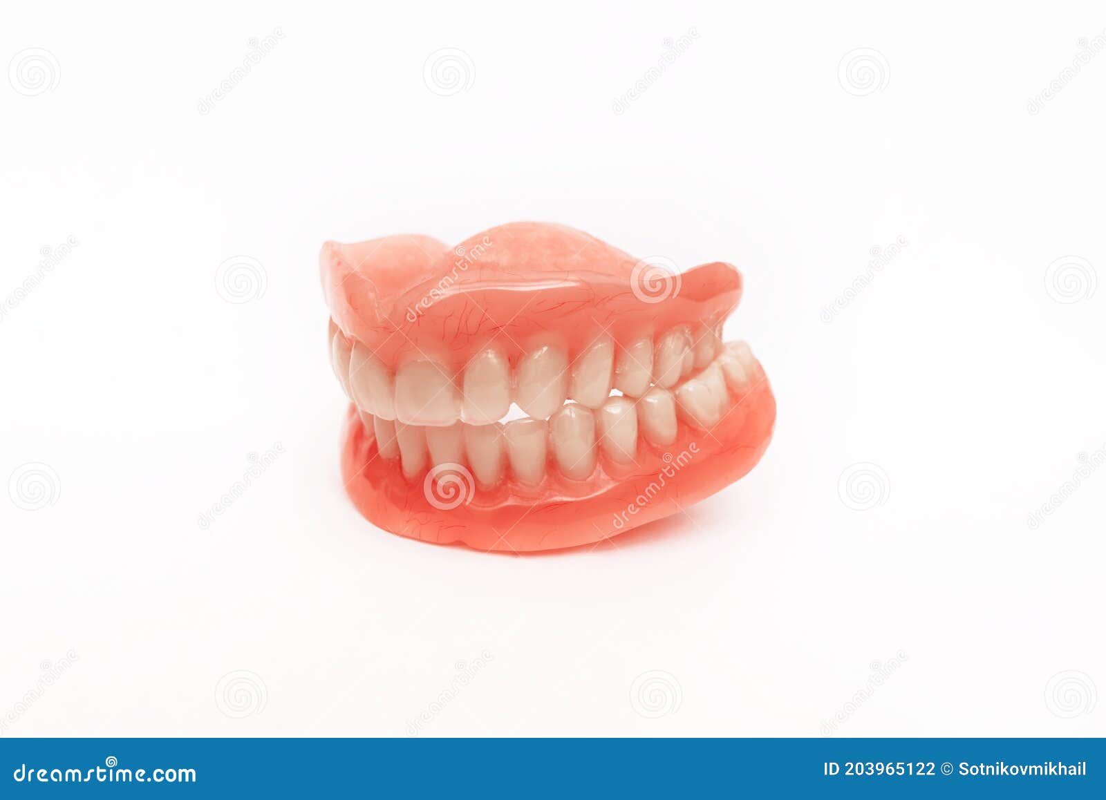 Full Removable Plastic Denture of the Jaws. Set of Dentures on a White ...