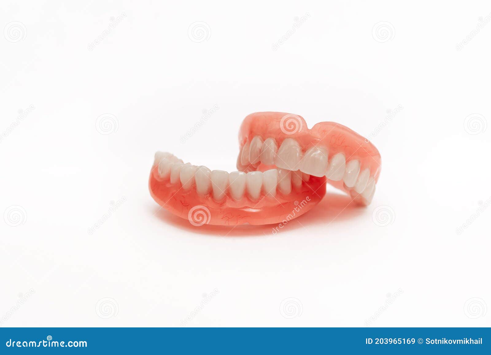 Full Removable Plastic Denture Of The Jaws. Set Of Dentures On A White ...