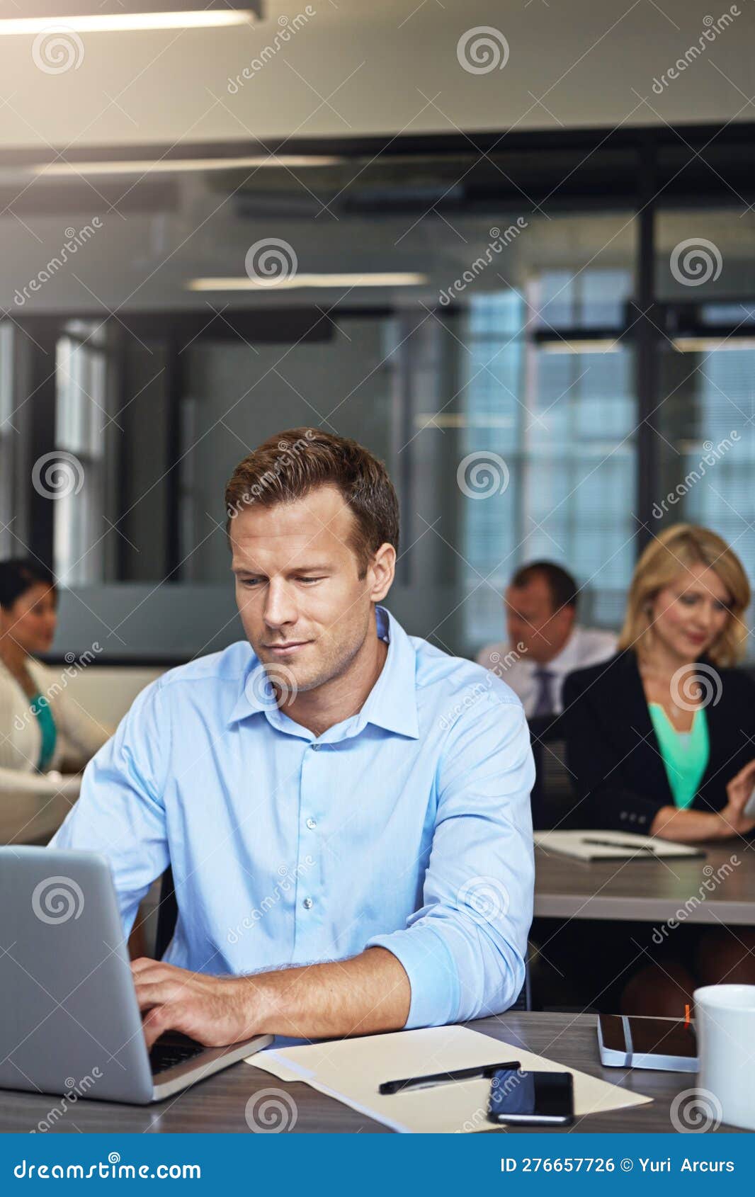Fully Engaged in His Work Tasks. a Businessman Using a Laptop at His ...