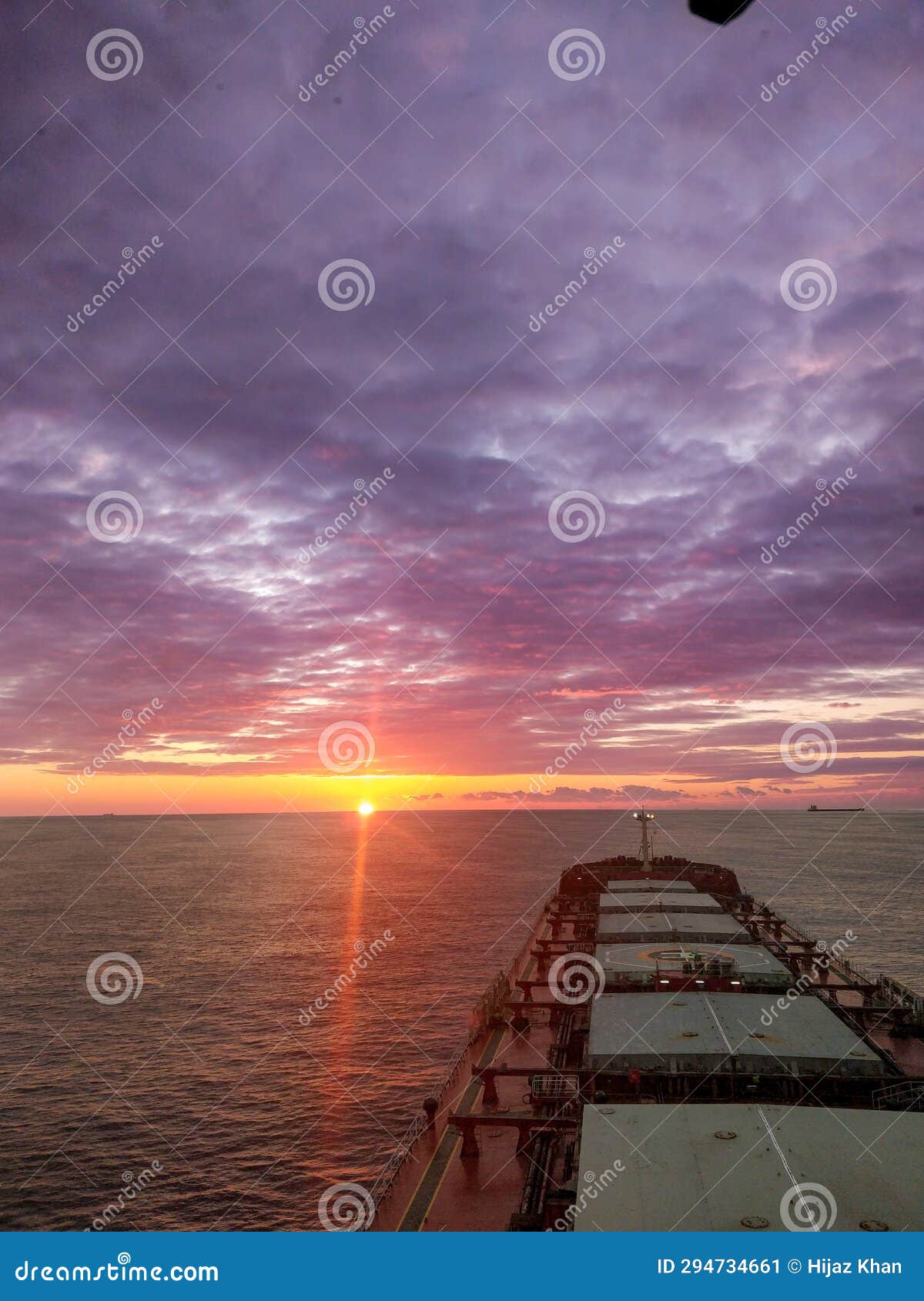 A Fully Loaded Bulk Carrier Ship Running Onto the Sunset Stock Image ...