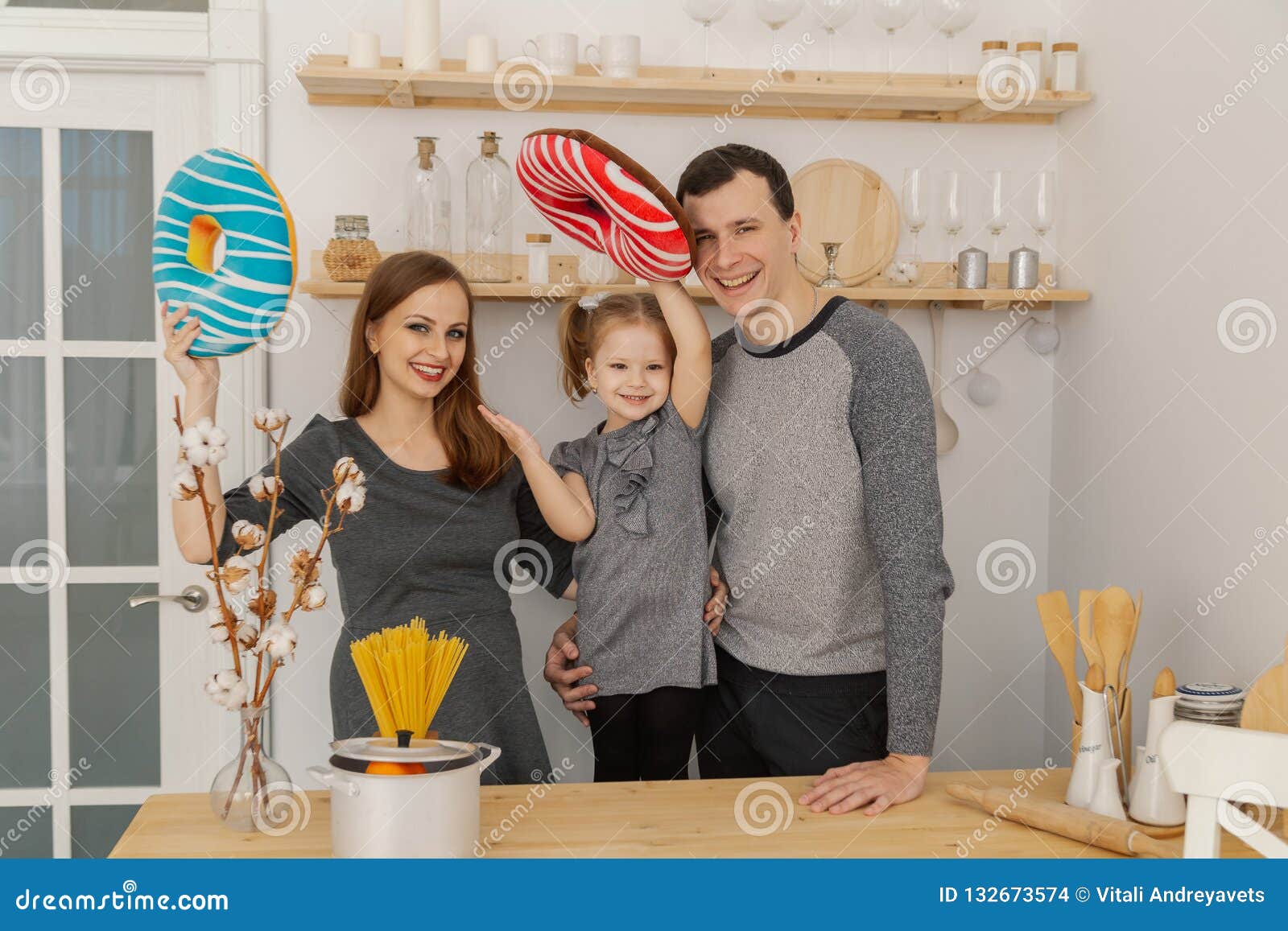 Fun and Beautiful Family of Three Having Fun in the Kitchen. Stock ...