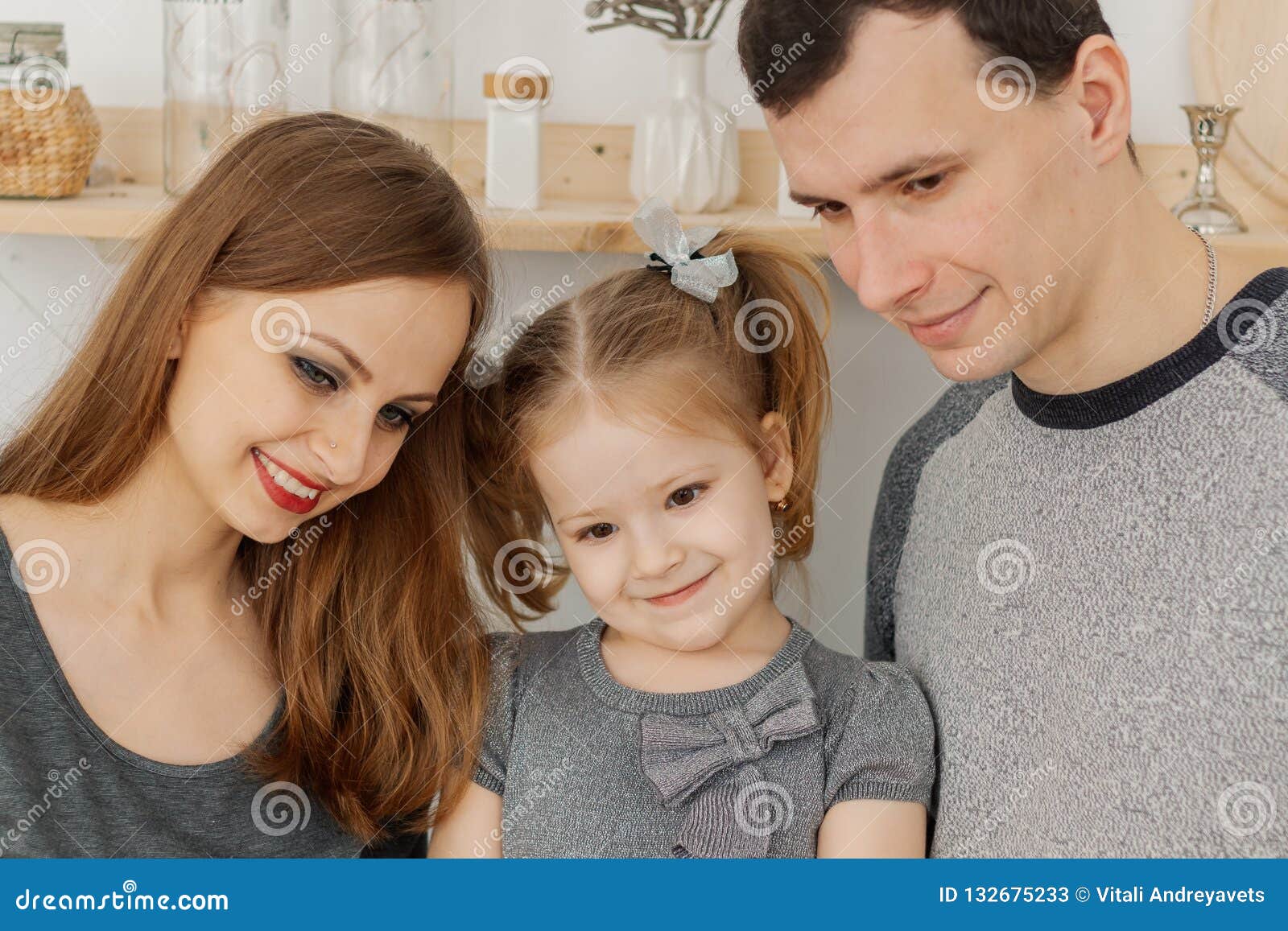 Fun and Beautiful Family of Three Having Fun in the Kitchen. Stock ...