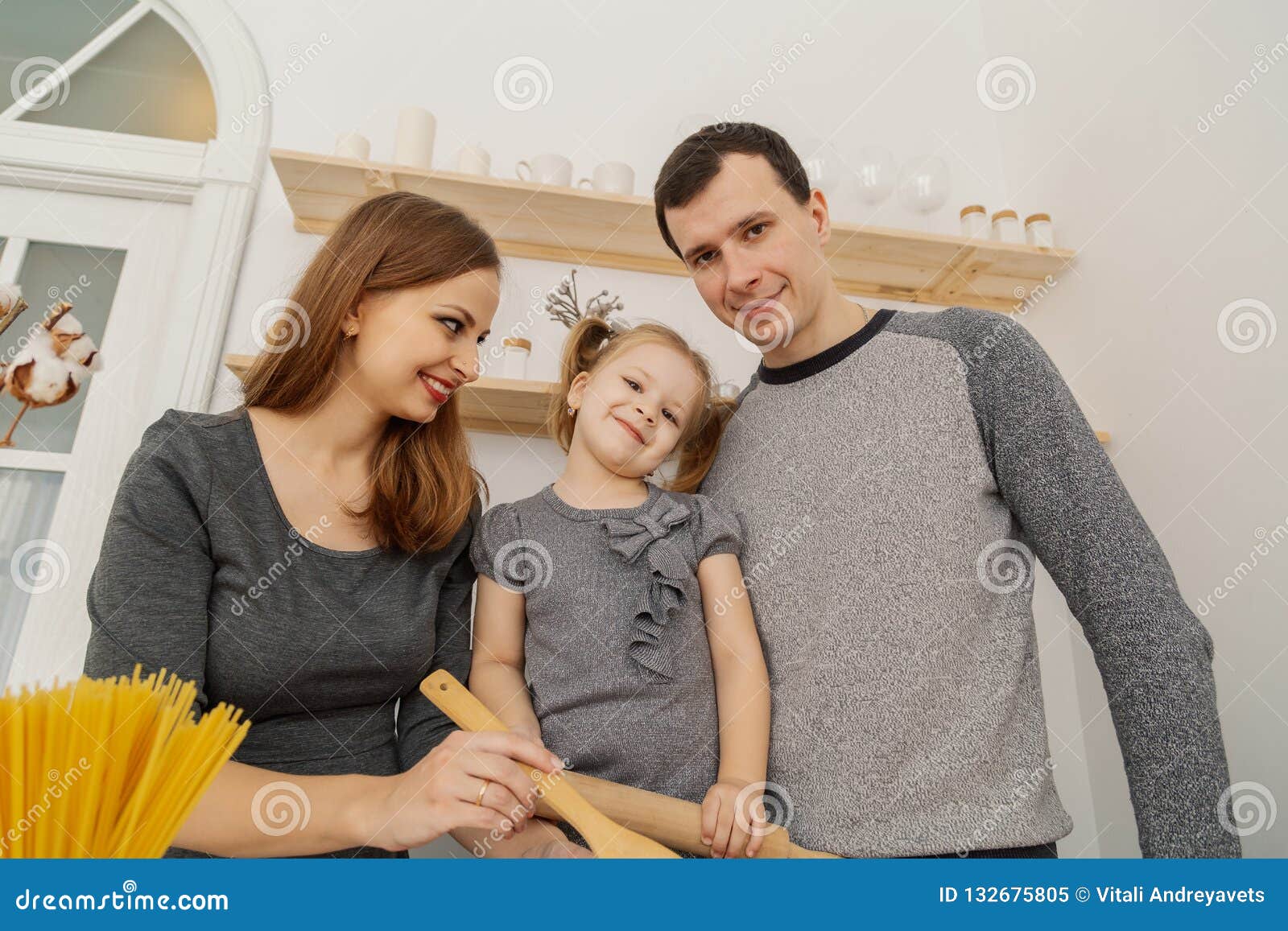 Fun and Beautiful Family of Three Having Fun in the Kitchen. Stock ...