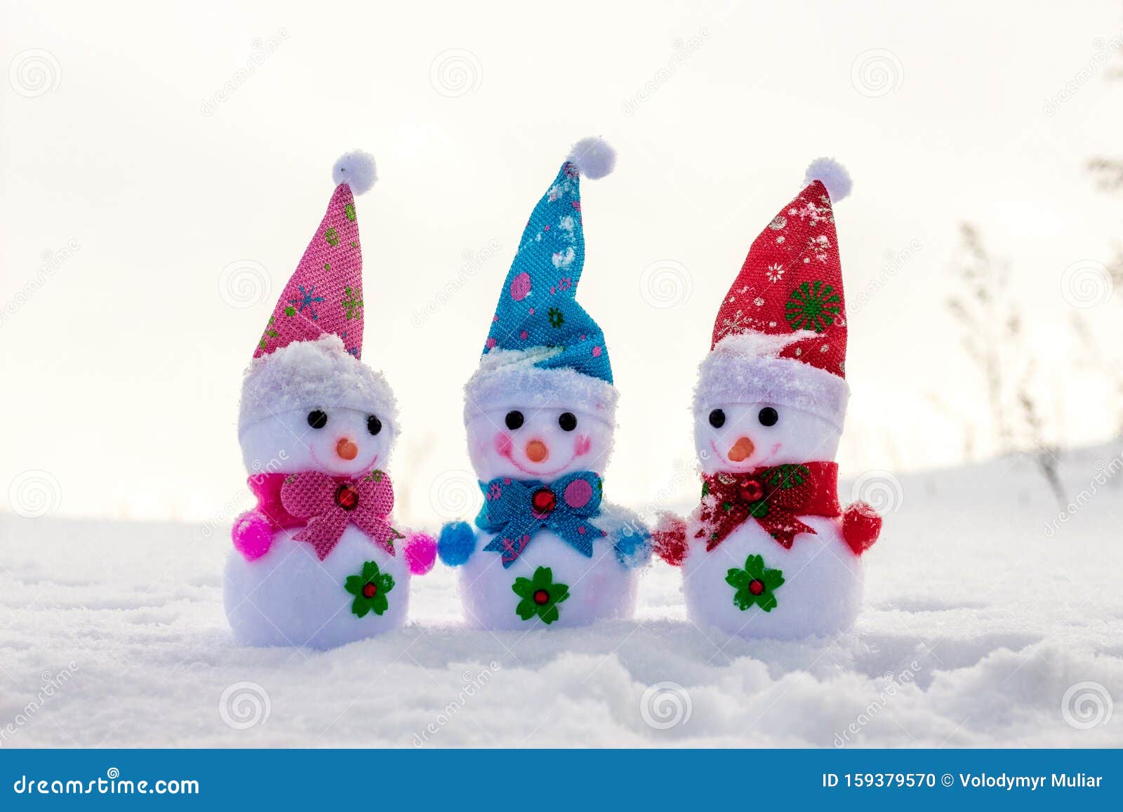 Fun and Friendly Company of Three Toy Snowmen in the Snow_ Stock Photo ...
