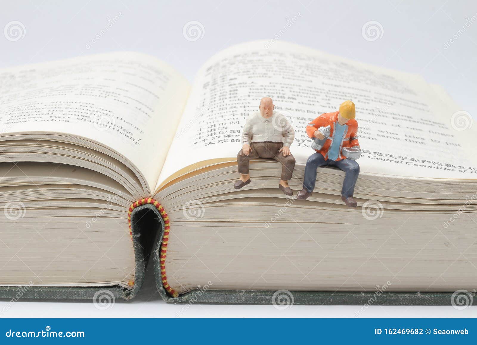 A Fun of Mini People:figure Sitting on Book Editorial Photography ...