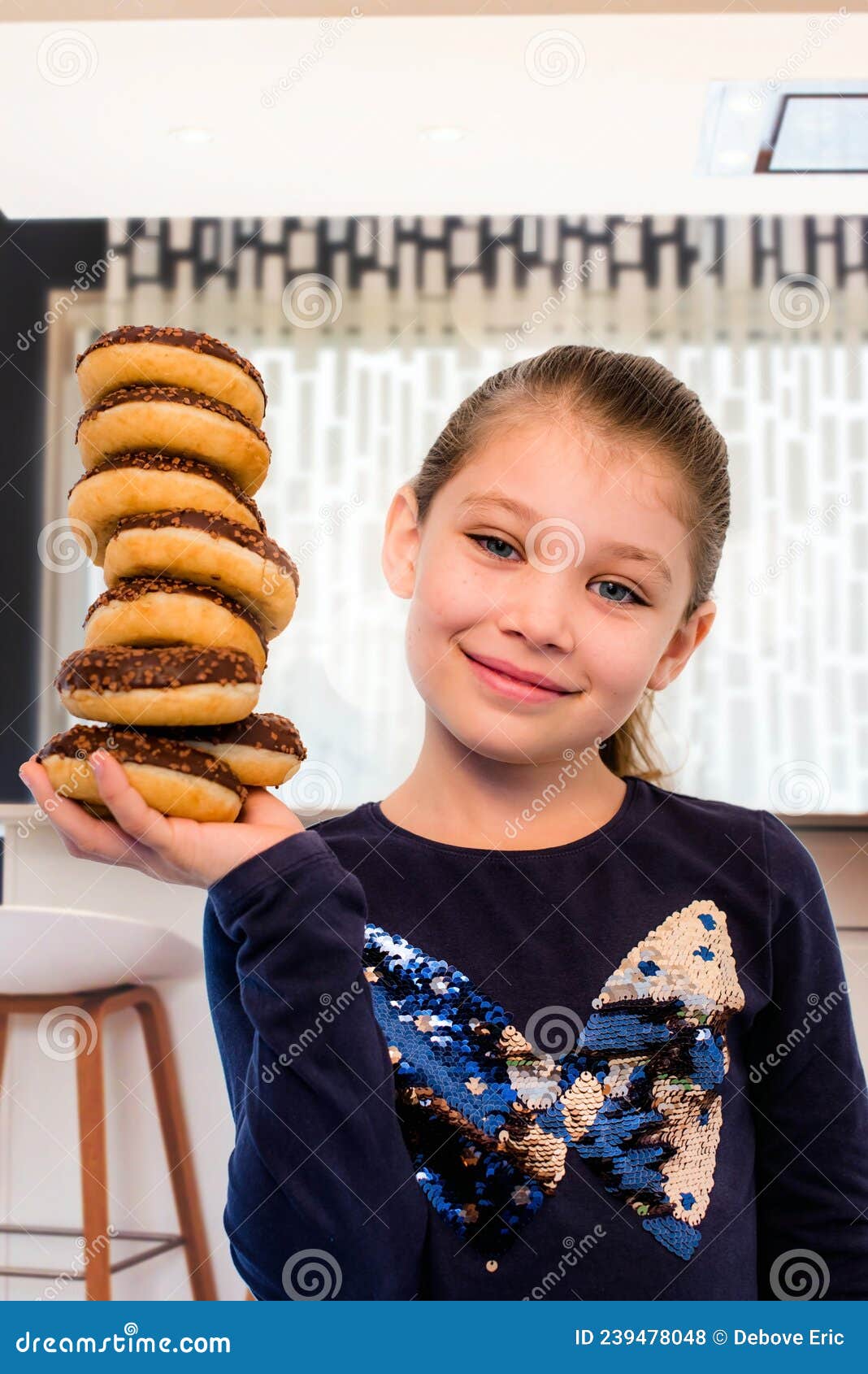 Fun Portrait of a Smiling Girl with Her Stack of Donuts in Balance ...