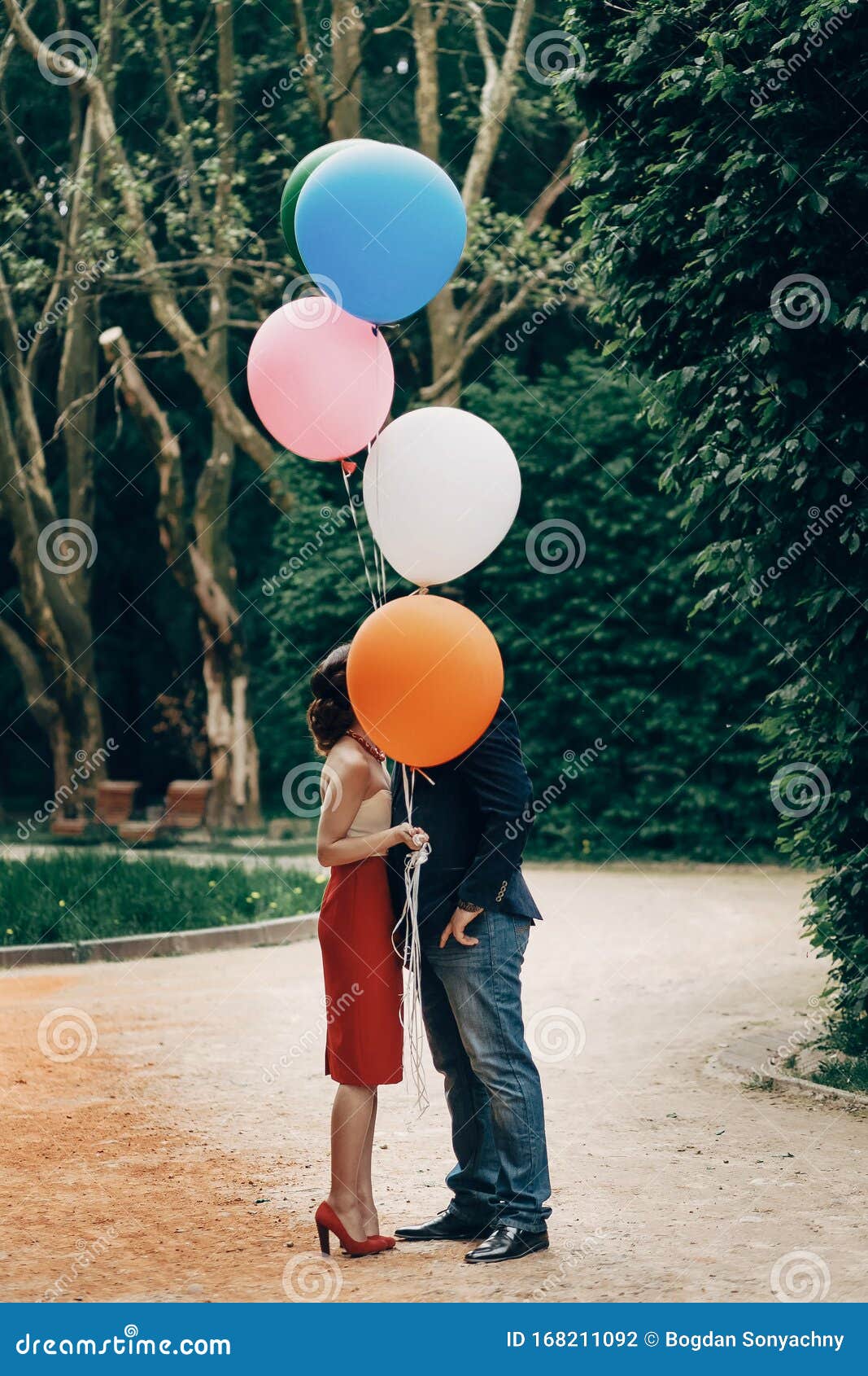 Fun Romantic Couple Kissing Outdoors Beautiful Woman Holding Balloons