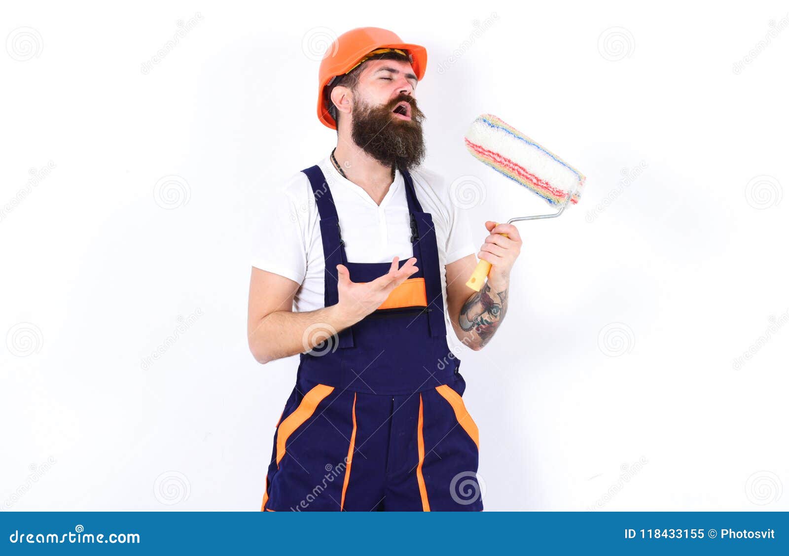 Fun at Work. Builder Holding Paint Roller As Microphone. Young Man ...