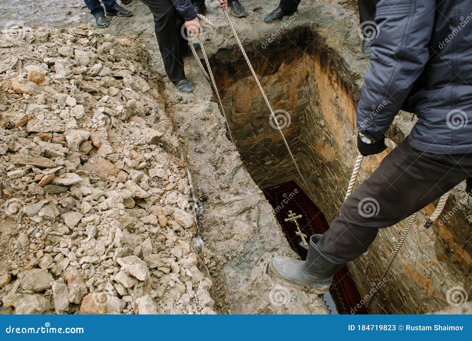 Funeral Home Employees they Put a Coffin Inside a Grave Stock Image ...