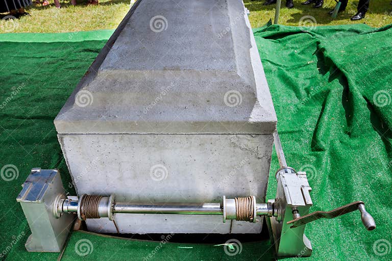 During a Funeral Service at a Cemetery, the Coffin is Placed on an ...