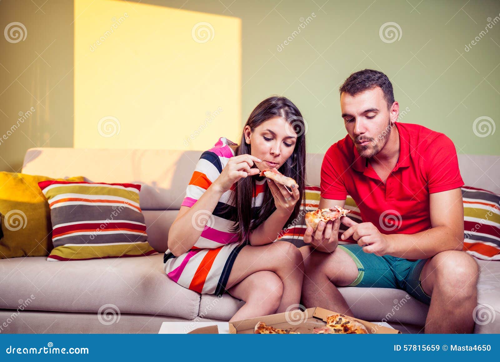 Funky Young Couple Eating Pizza on a Couch Stock Image - Image of happy ...
