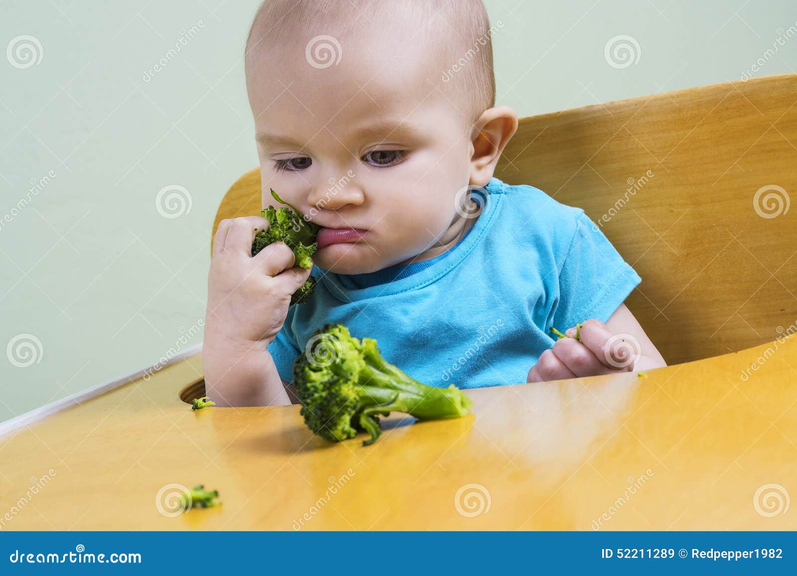 Funny baby eating broccoli stock image. Image of caucasian - 52211289