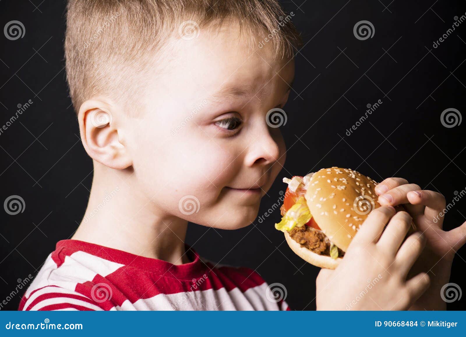 Funny boy eating Hamburger stock photo. Image of meat - 90668484