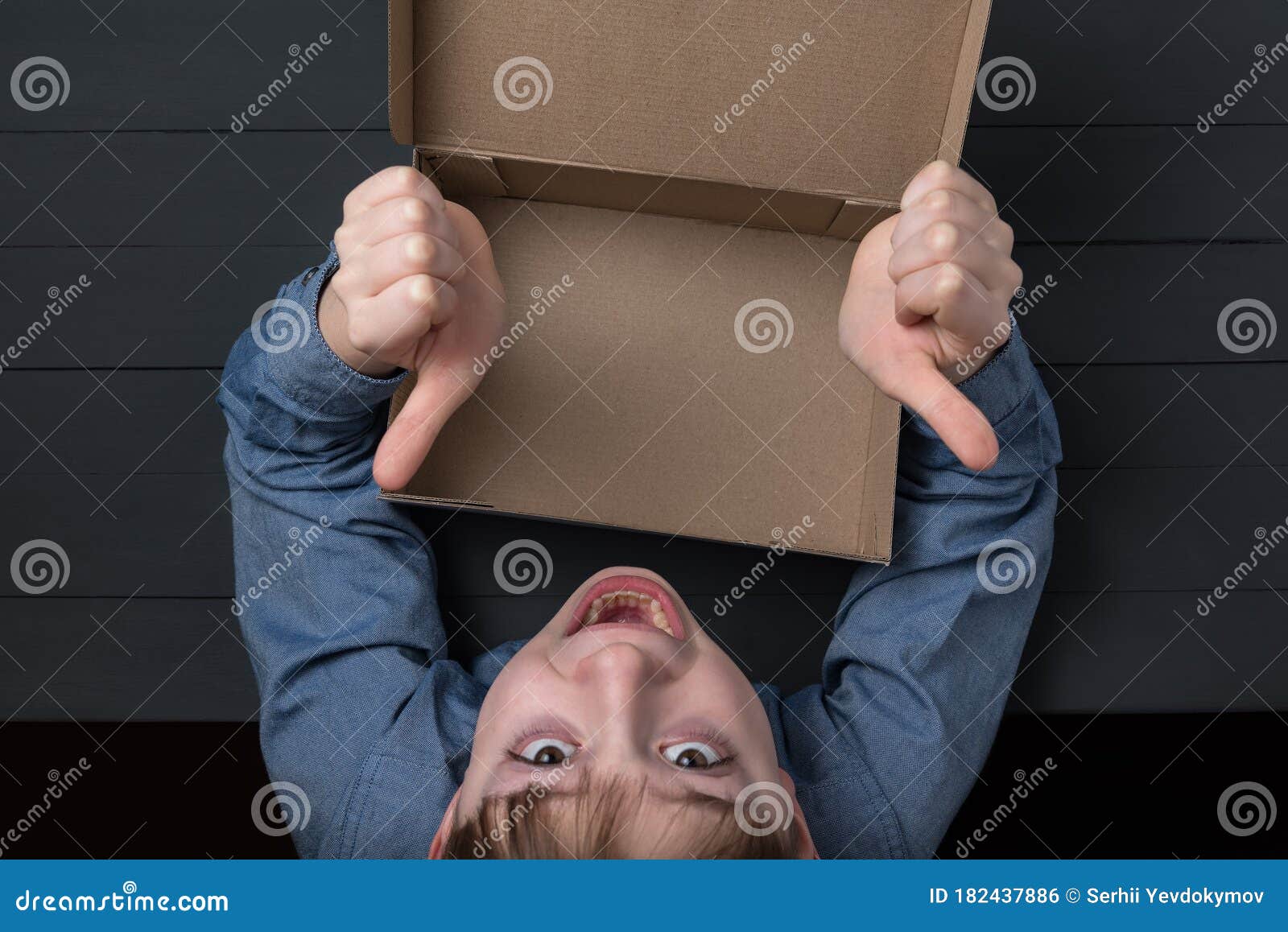 Funny Boy with an Open Empty Box Shows Thumbs Up. Top View Foto de ...