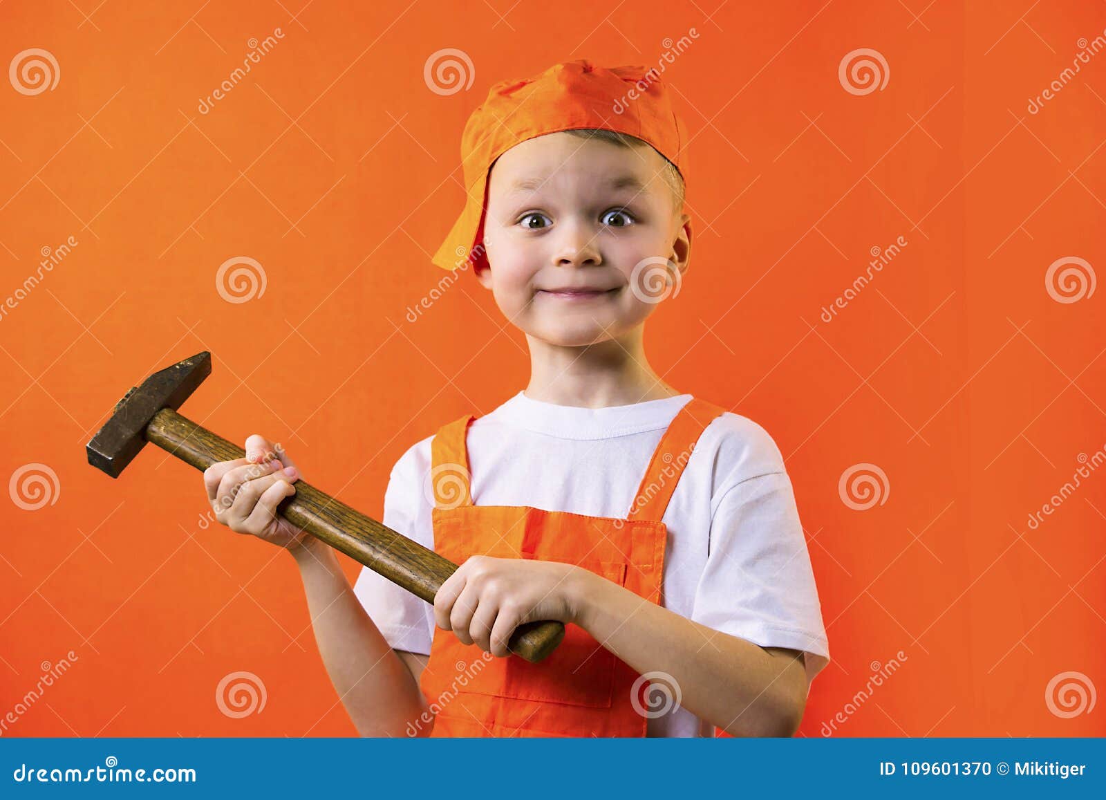 Funny Builder Boy in Uniform Holds a Hammer Stock Photo - Image of ...