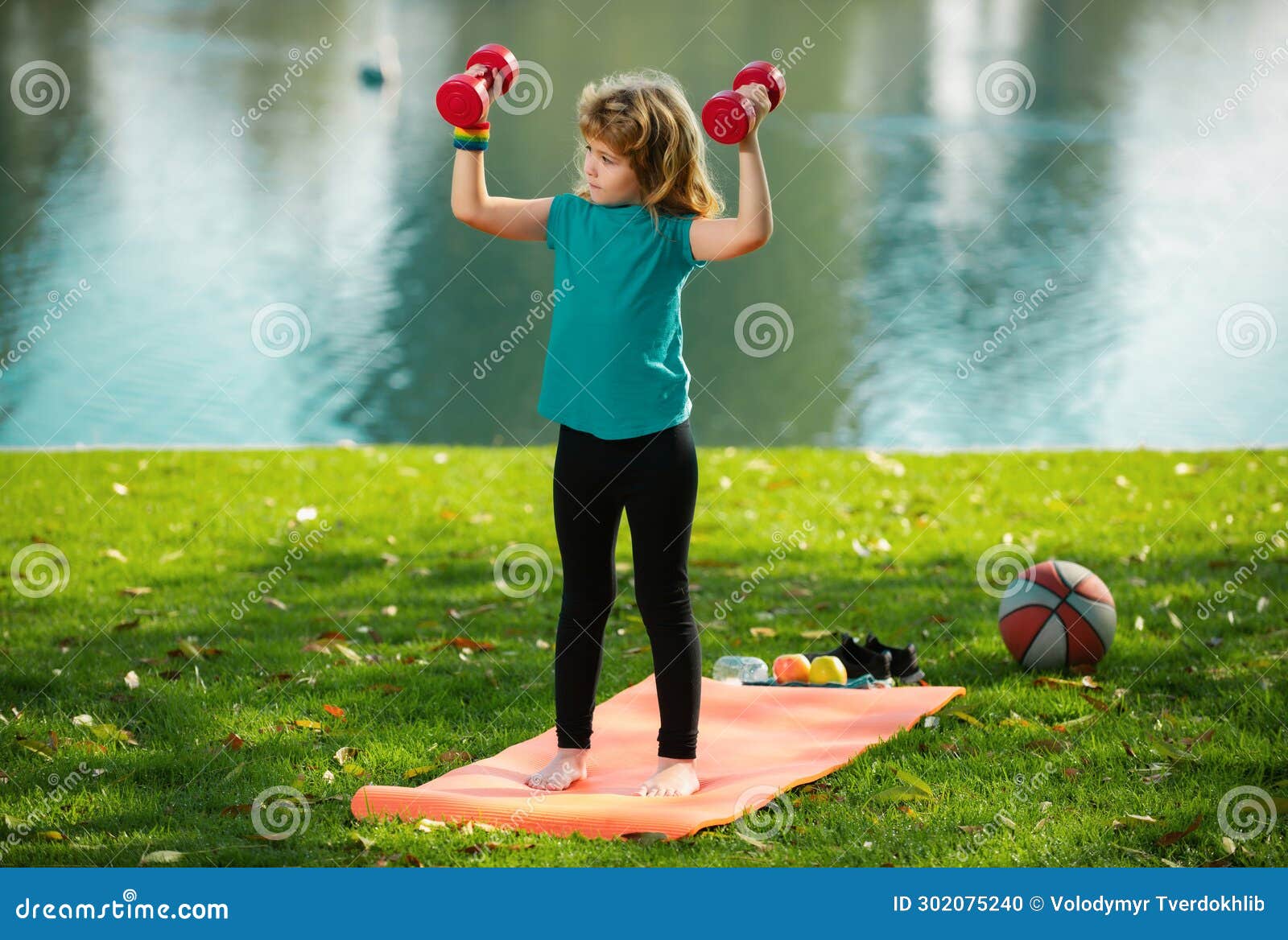 Funny Child Lifting the Dumbbells in Backyard Outside. Kids in Training ...