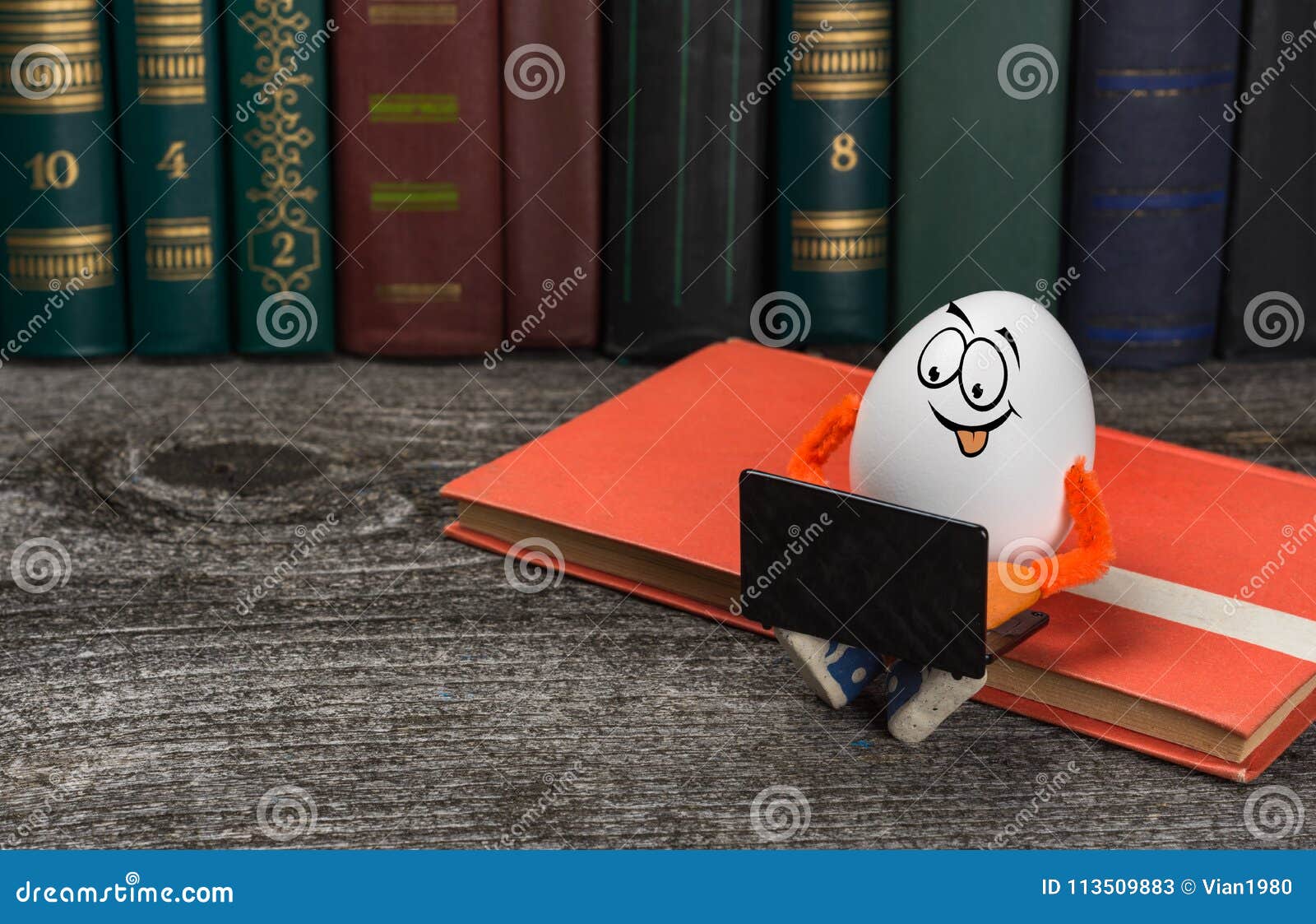 Easter Egg with Notebook Computer Sitting on a Book in a Library Stock ...