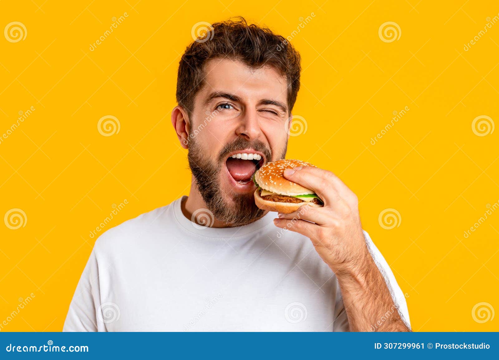 Funny Eater Guy Biting Burger Winking Eye at Camera, Studio Stock Image ...