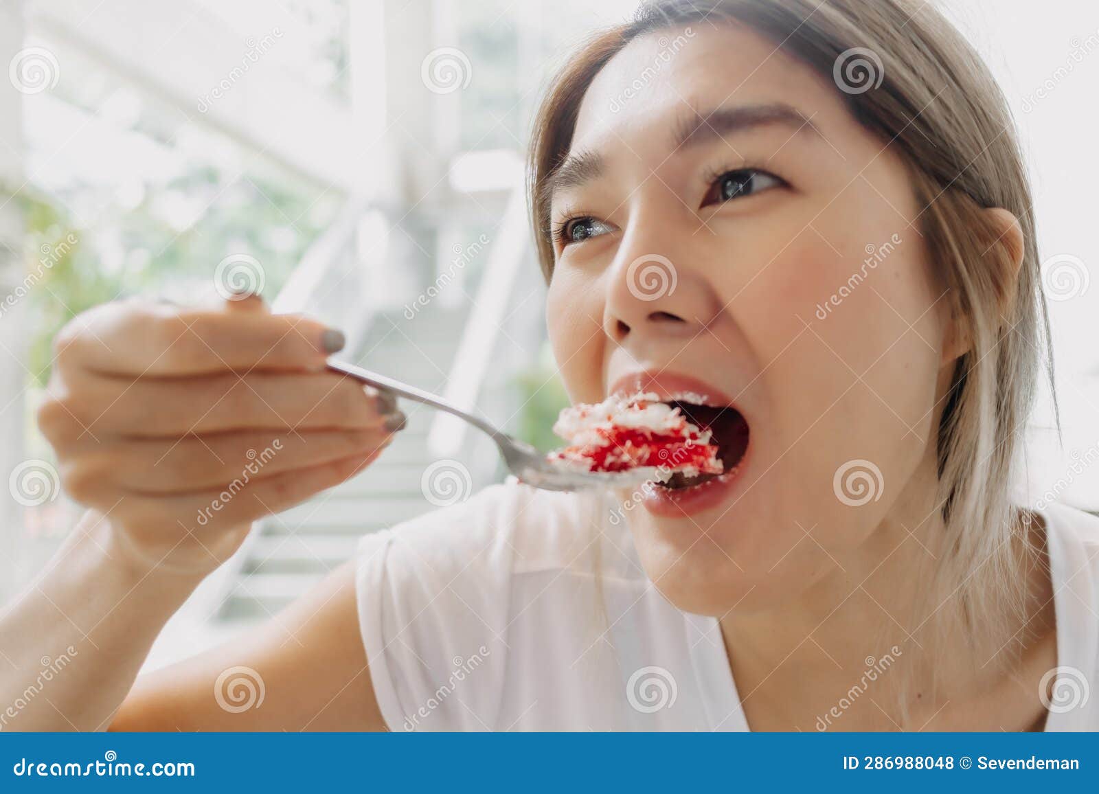 Funny Face Of Happy Woman Eating Cake Carelessly In The Cafe Stock